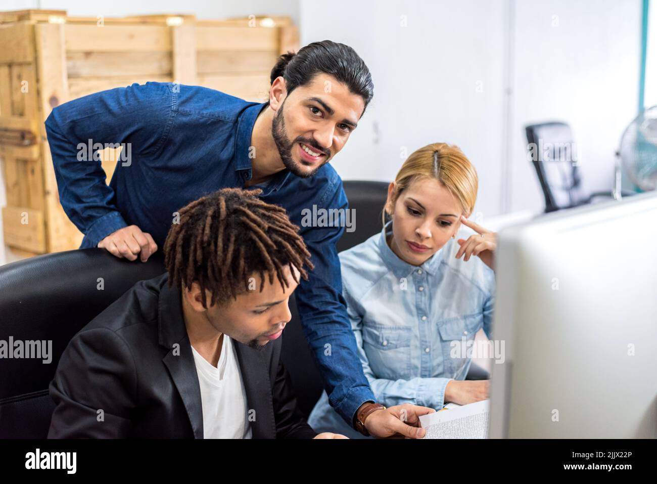 Group of optimistic multiracial coworkers in formal wear working with ...