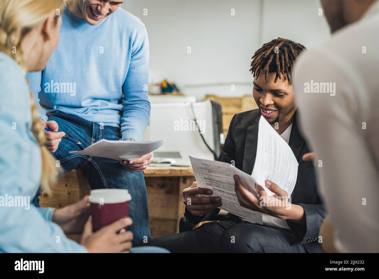 Concentrated group of workers in formal wear working with documents ...