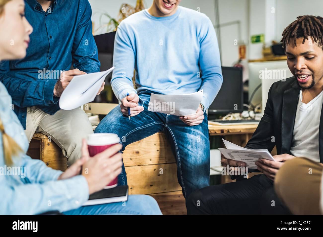 Concentrated group of workers in formal wear working with documents ...