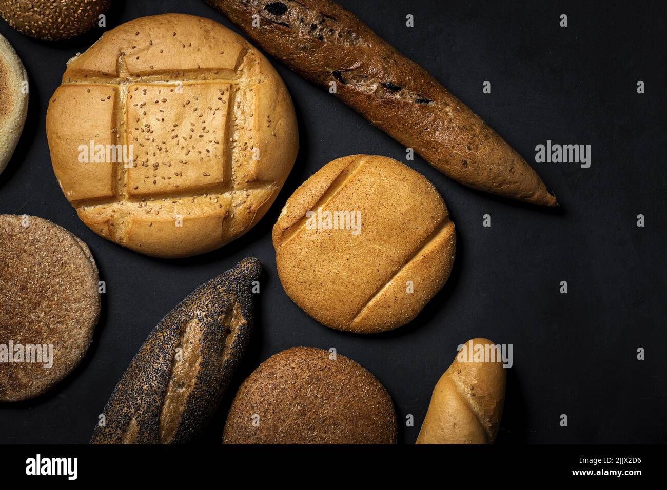 Top View Mix Of Delicious Round Wholegrain Bread Loaves And Baguettes