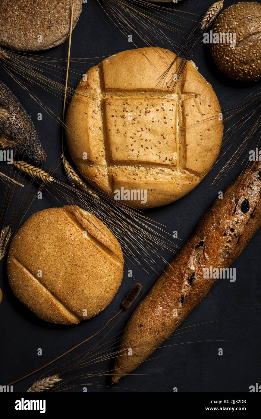 Top view background of assorted bread loaves and baguette placed near ...