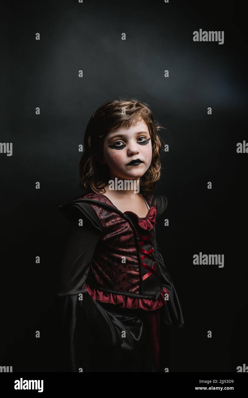 Creepy unemotional little girl with dark makeup in enchantress costume ...