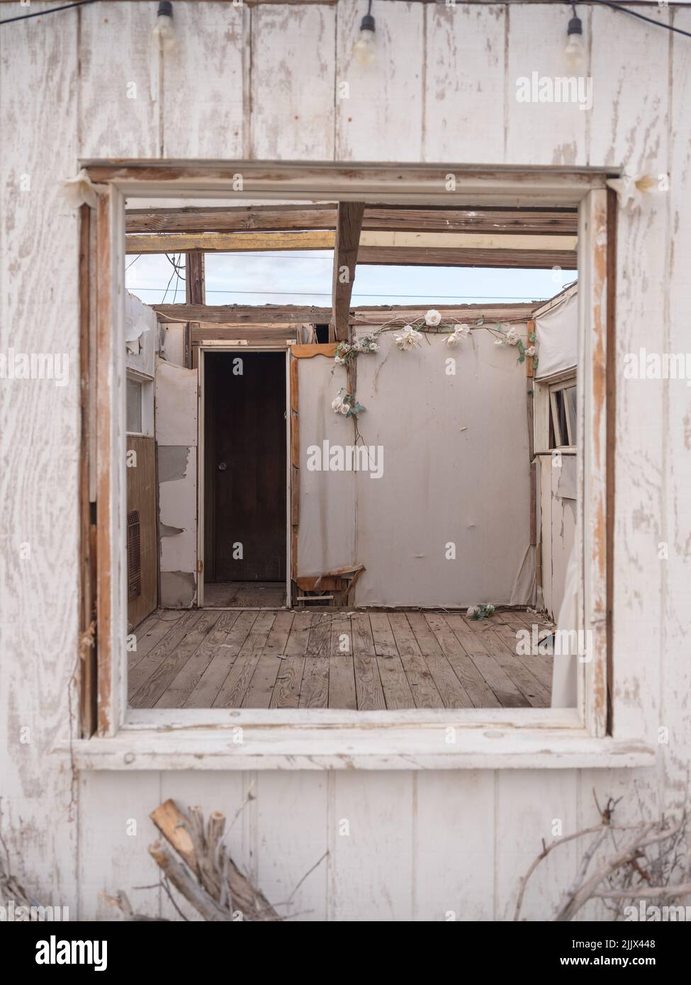 Weathered broken room of abandoned roofless cabin located behind square ...