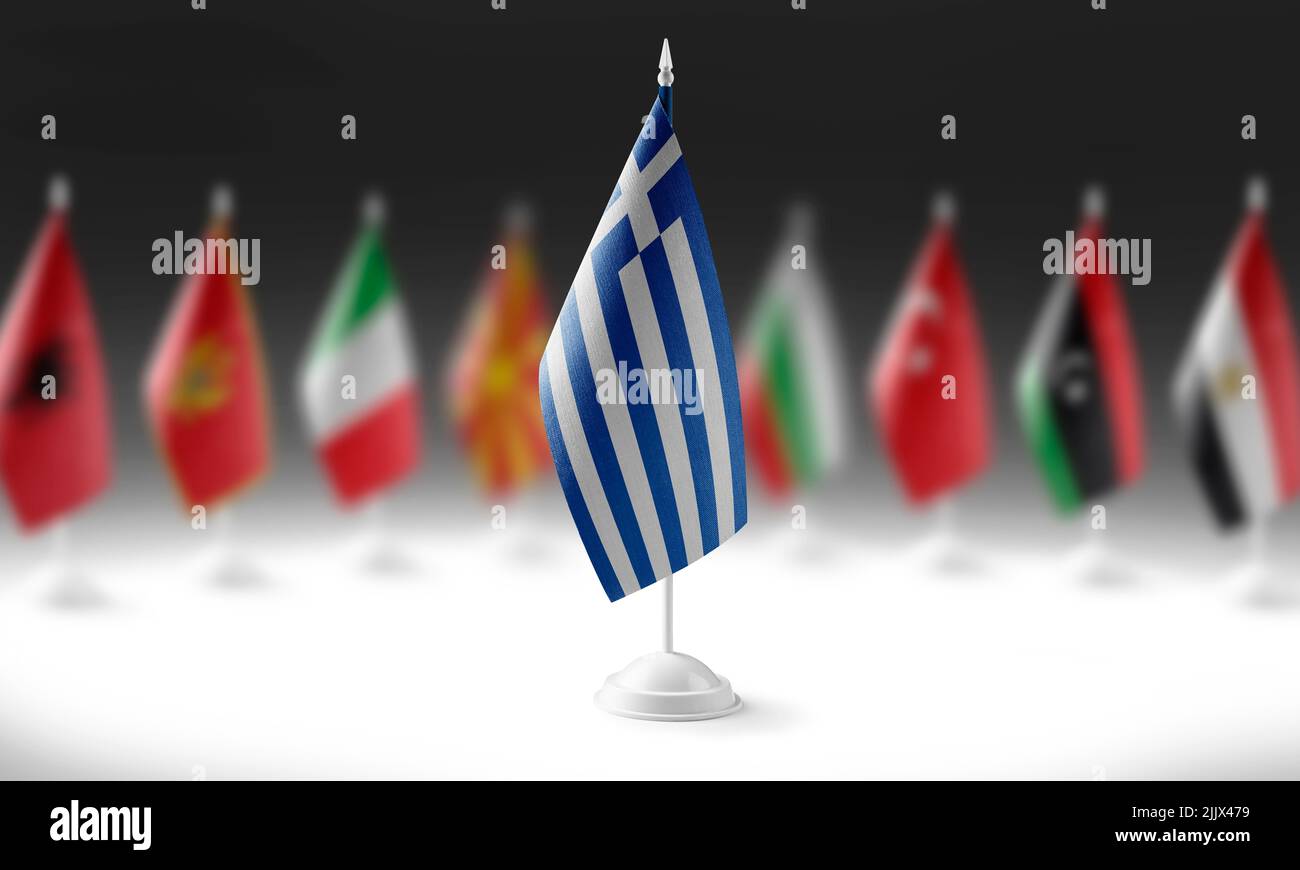 The national flag of the Greece on the background of flags of other ...