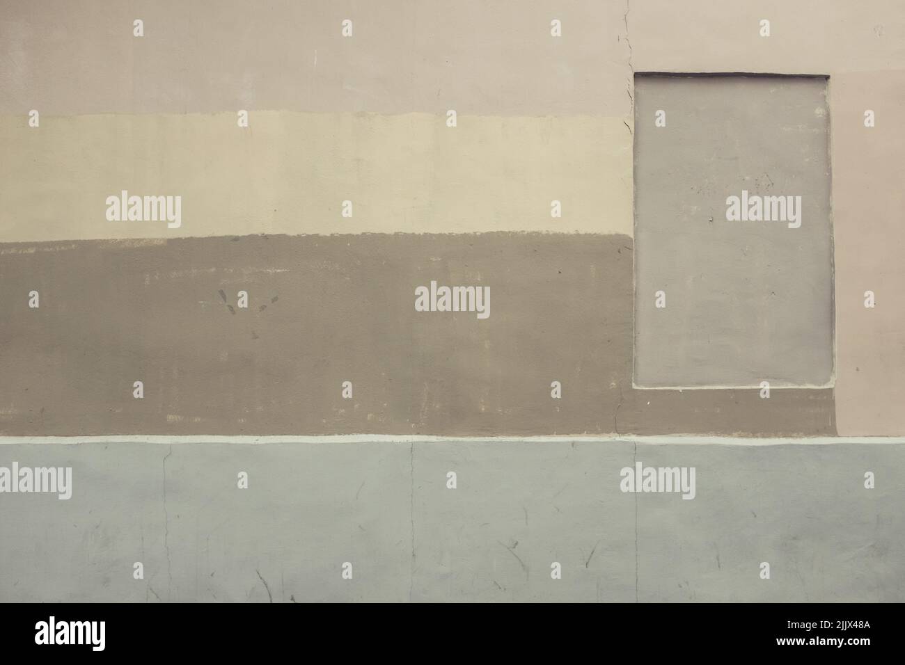 Concrete wall of building painted with stripes of various shades of ...