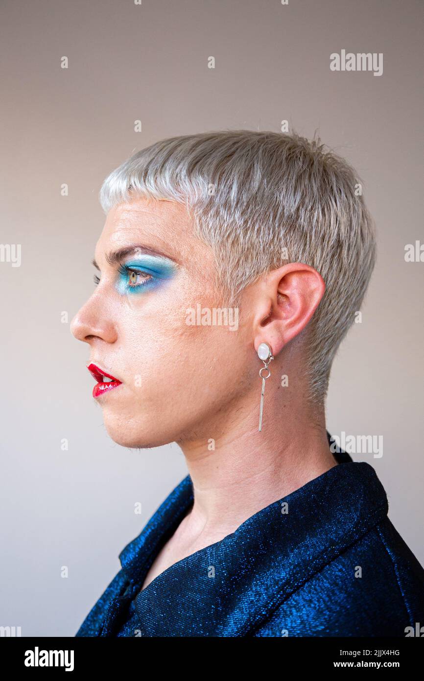 Portrait of young transgender man with makeup looking away Stock Photo ...