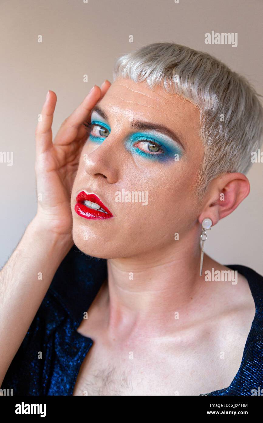 Portrait of young transgender man with makeup looking at camera Stock ...