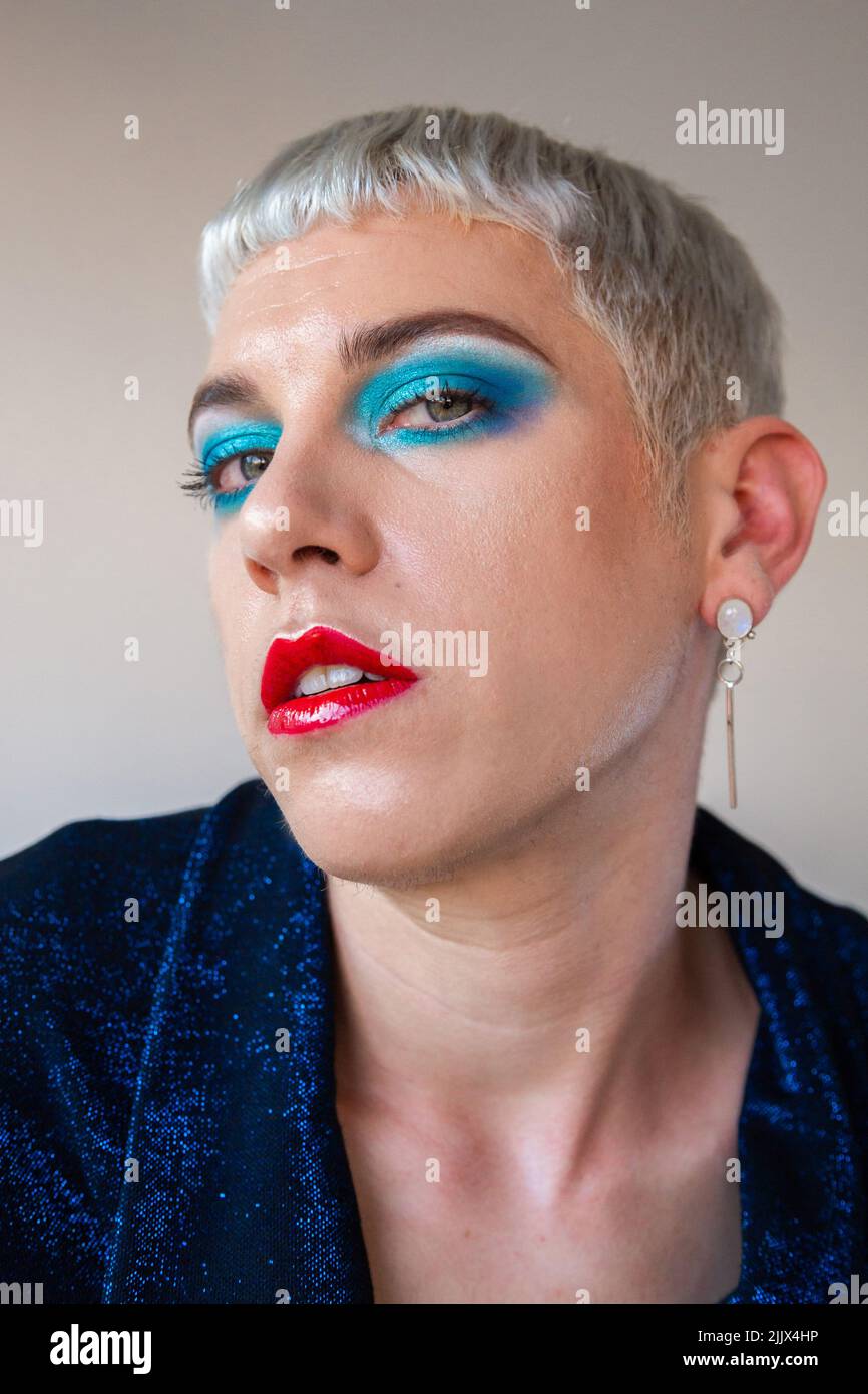 Portrait of young transgender man with makeup looking at camera Stock ...