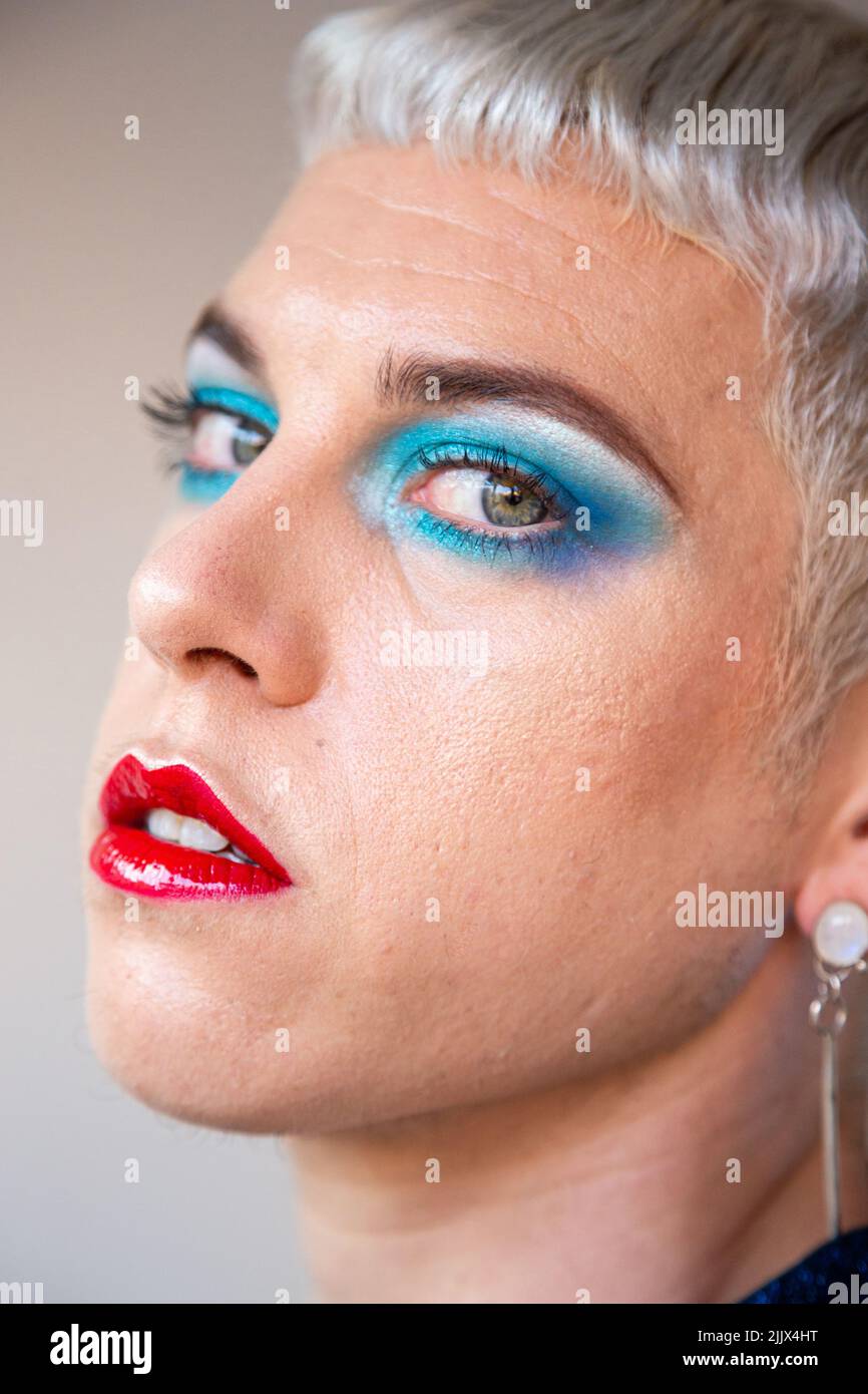 Portrait of young transgender man with makeup looking at camera Stock ...