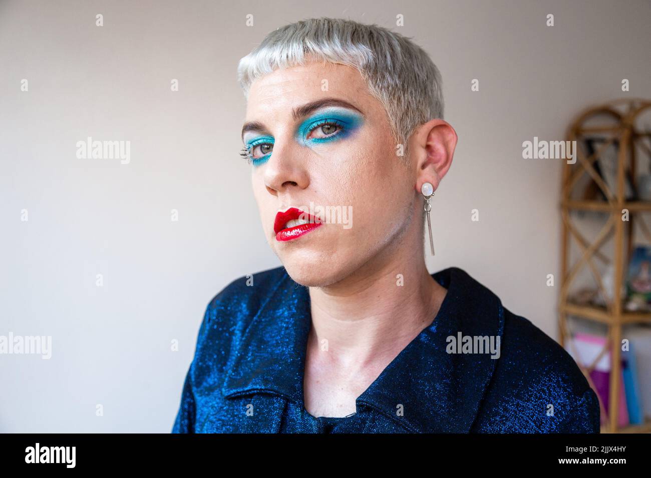 Portrait of young transgender man with makeup looking at camera Stock ...