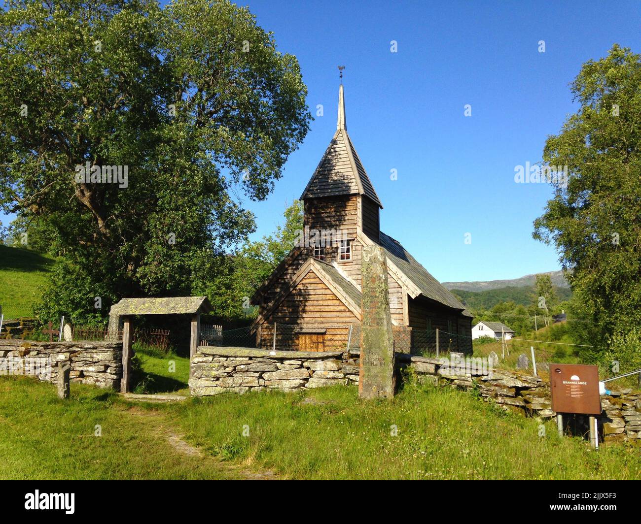 the Holdhus stave church in Fusa, Western Norway surrounded with trees ...