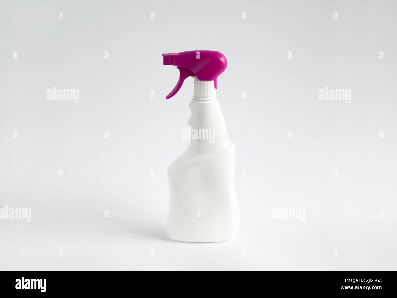 White blank plastic spray detergent bottle with a violet sprayer ...