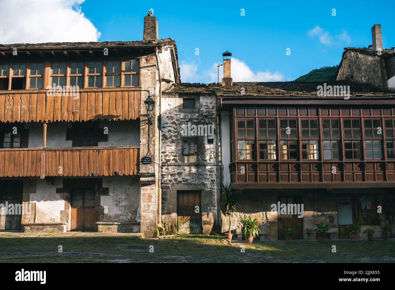 Exterior of aged stone house with shabby doors and balconies located in ...