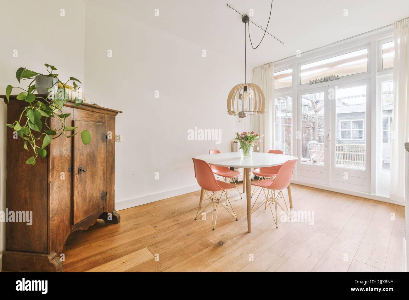 Table and chairs next to vintage cupboard in modern dining room ...