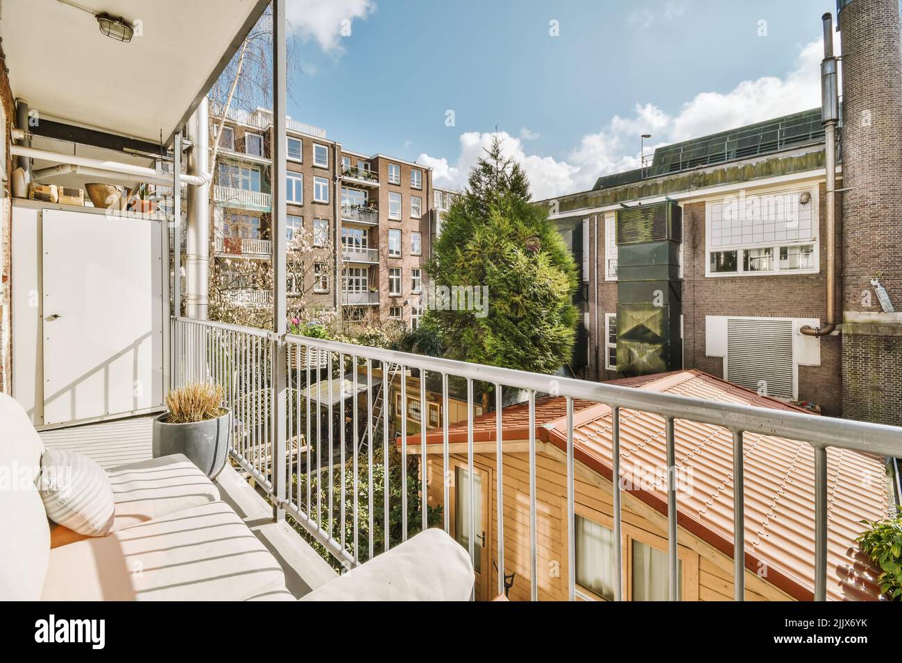 Comfortable sofa placed near metal fence on terrace of residential ...