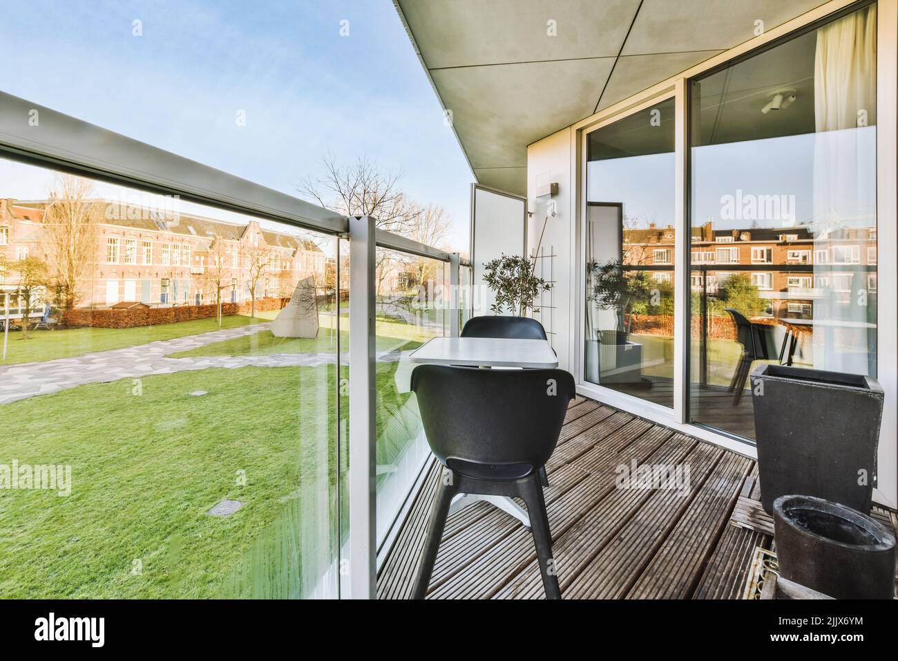 View from balcony of modern apartment building with furniture and glass ...