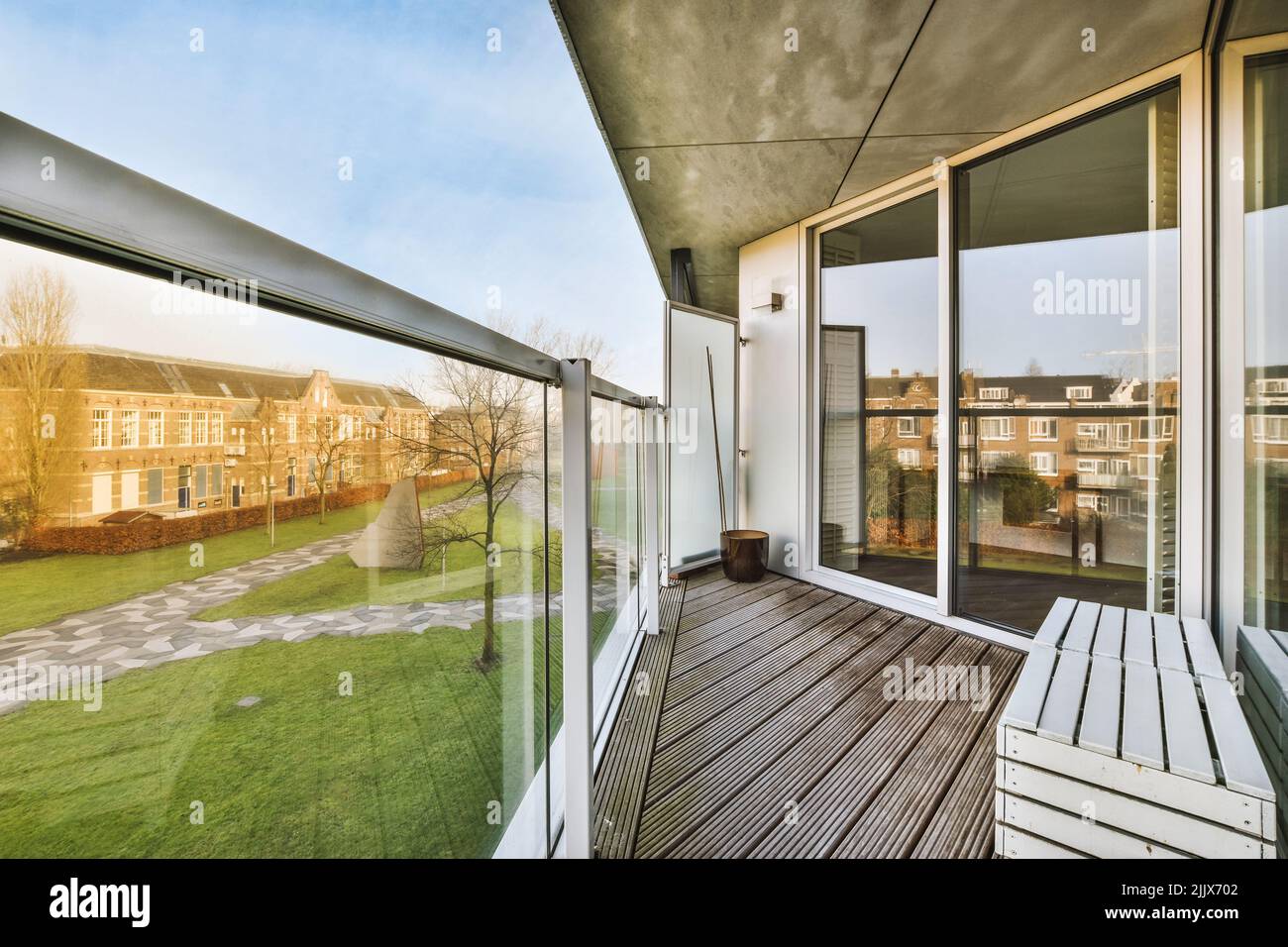 View from balcony of modern apartment building with glass fence and ...