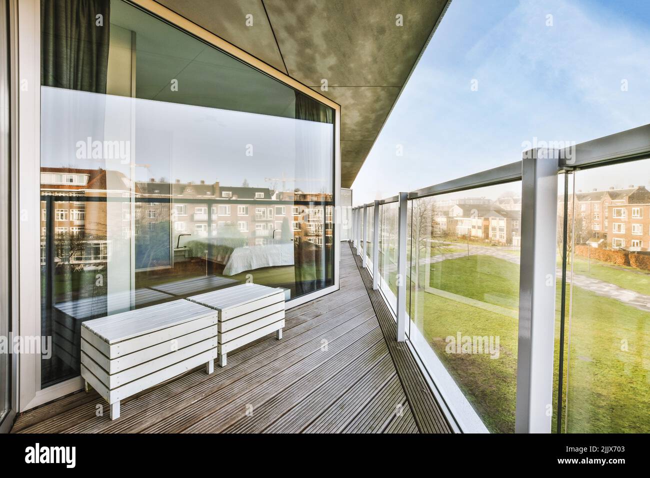 View from balcony of modern apartment building with glass fence and ...