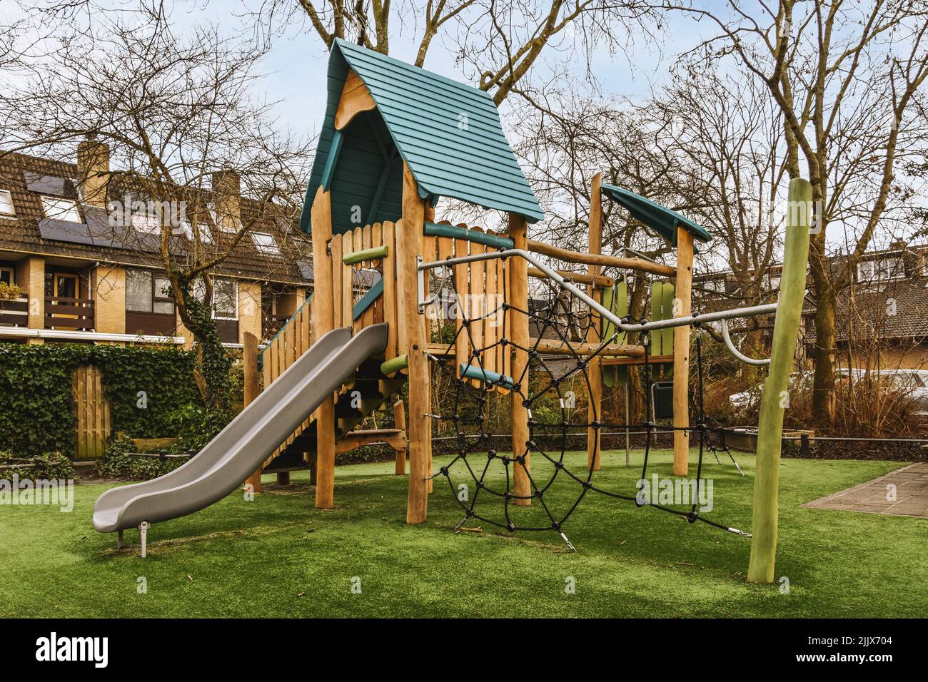 Children's playground in the back garden of a house next to other ...