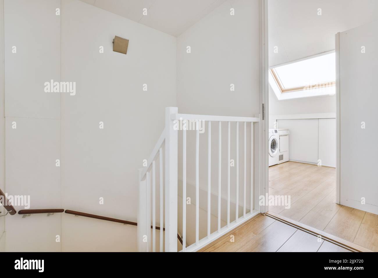 Interior of a house with stairs to an down floor in a bright ...