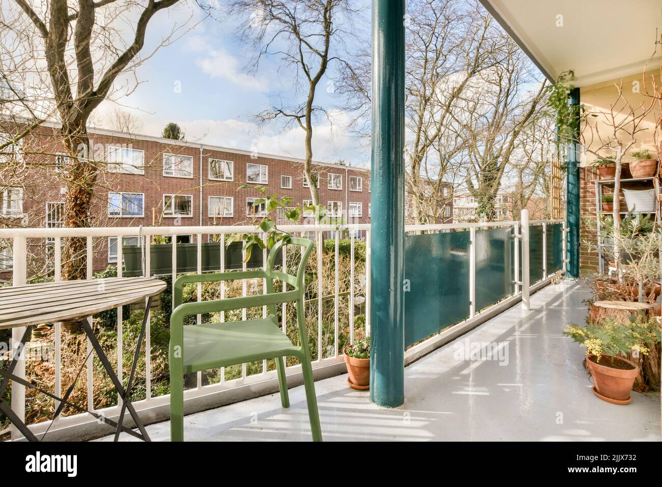 Views of multiple houses and backyard from metal balcony under cloudy ...