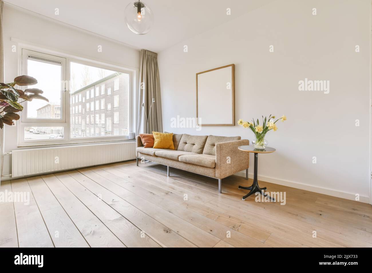 Interior of modern home with sofa next to a bright window Stock Photo ...