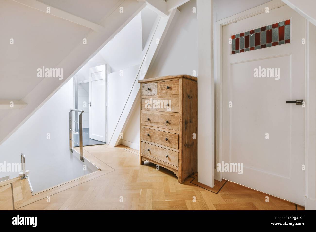 Interior of a house with stairs to an down floor in a bright ...