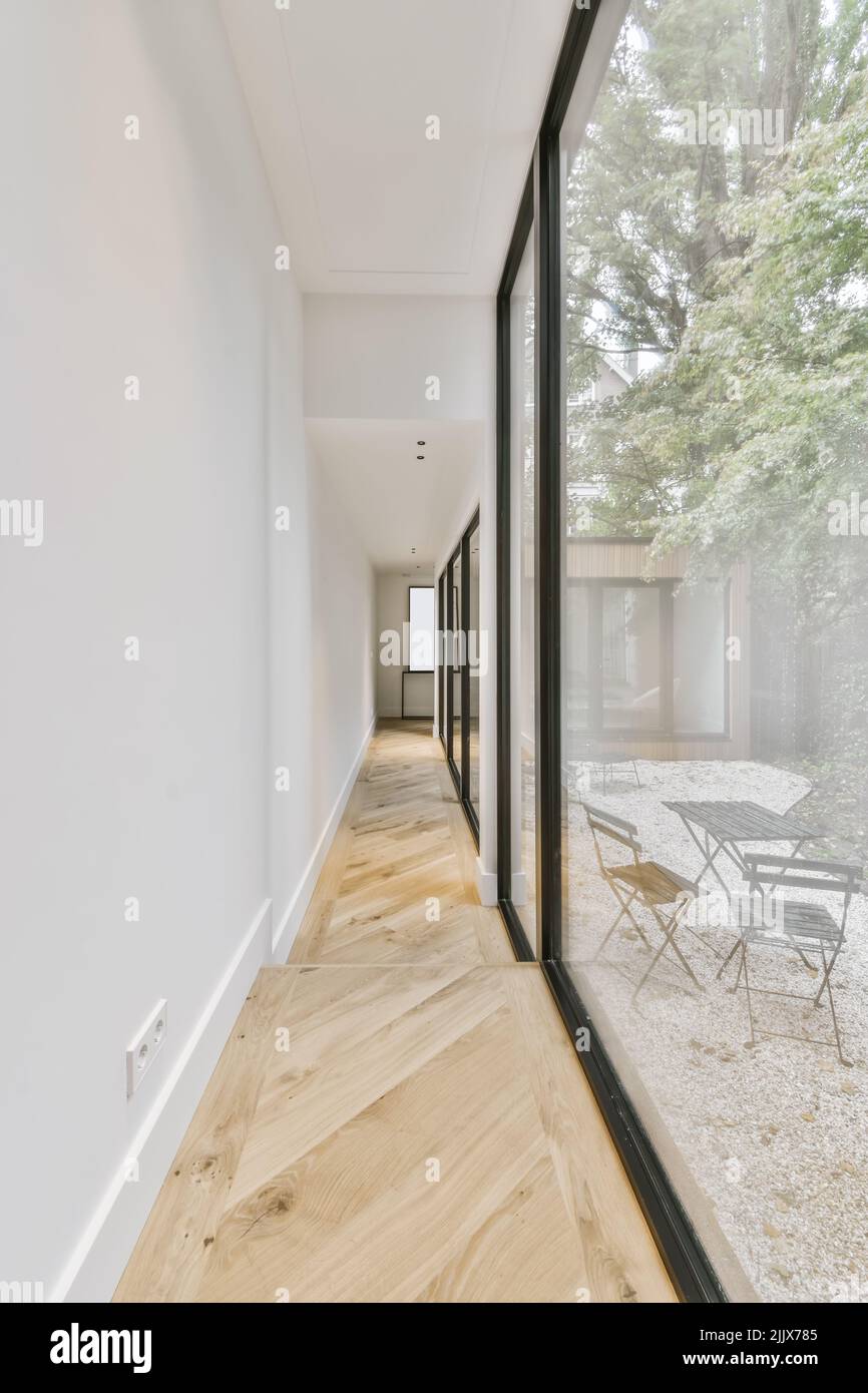 Passage way by window in modern house Stock Photo - Alamy