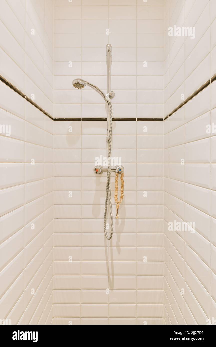 Interior of bathroom with empty shower cabin with white tiled walls in ...