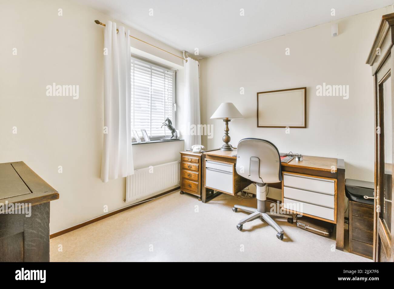 Bright room with a table and chair next to a window Stock Photo - Alamy