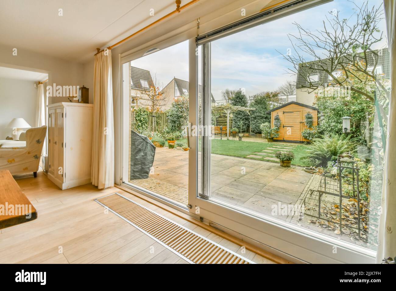 Interior of a house with a view through the window to the rear garden ...