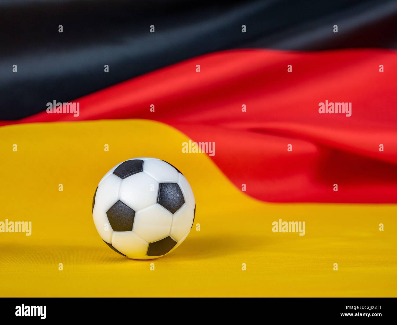 Soccer ball on the German flag. The ball against the background of the ...