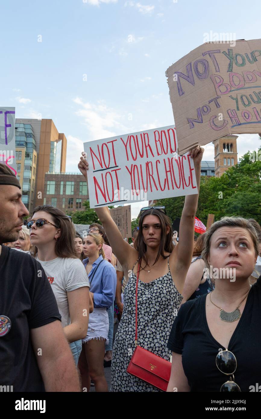 The protesters holding out cardboard signs about body freedom after ...