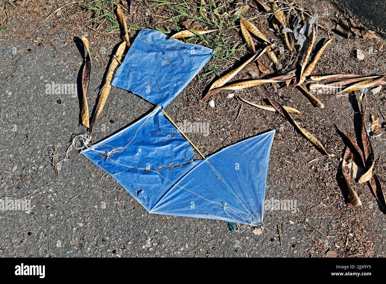 Broken blue kite on the floor, Rio Stock Photo - Alamy