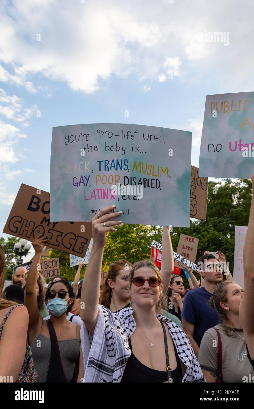 The protesters holding out cardboard signs about body freedom after ...