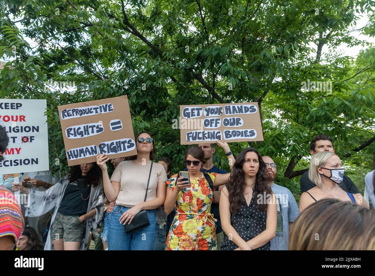 The protesters holding out cardboard signs about body freedom after ...