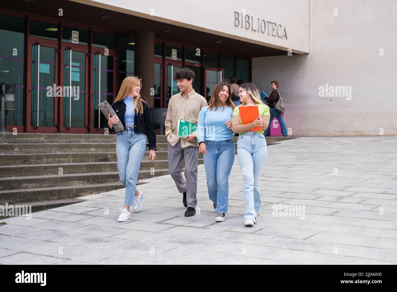 Group of college students leaving the library to study Stock Photo - Alamy