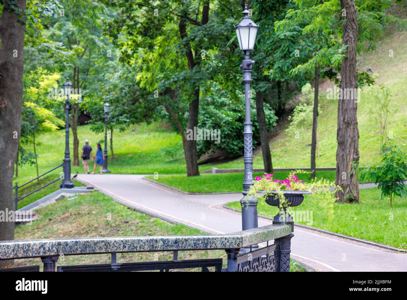 Flower vase stone vase, antique metal street lamp against the ...