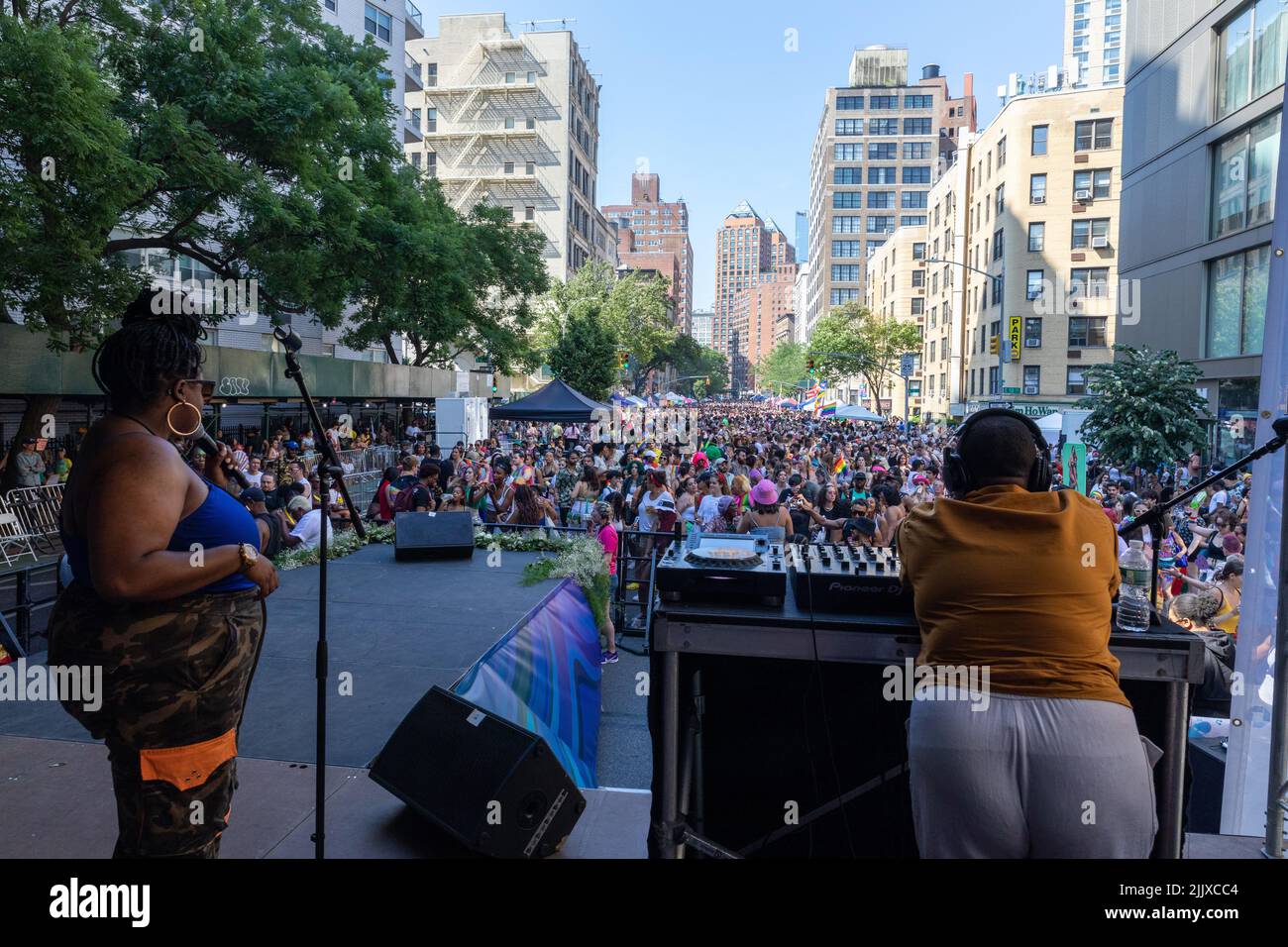 A large crowd enjoying a live DJ performance at Pride Month Parade 2022 ...