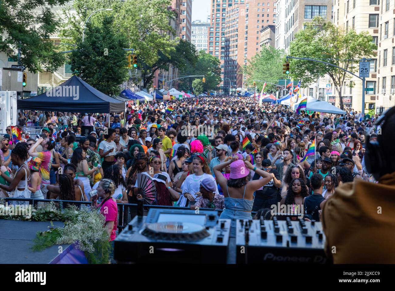 A large crowd enjoying a live DJ performance at Pride Month Parade 2022 ...