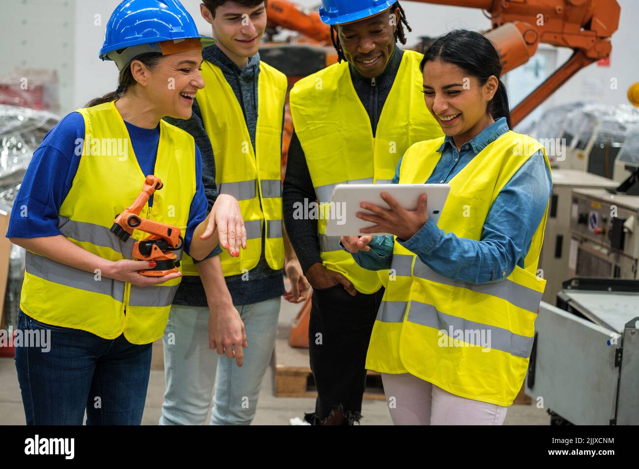 Group of factory workers analyzing data through the tablet Stock Photo - Alamy