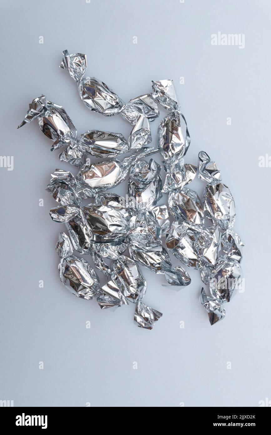 Hands full of candies in silver shells Stock Photo - Alamy