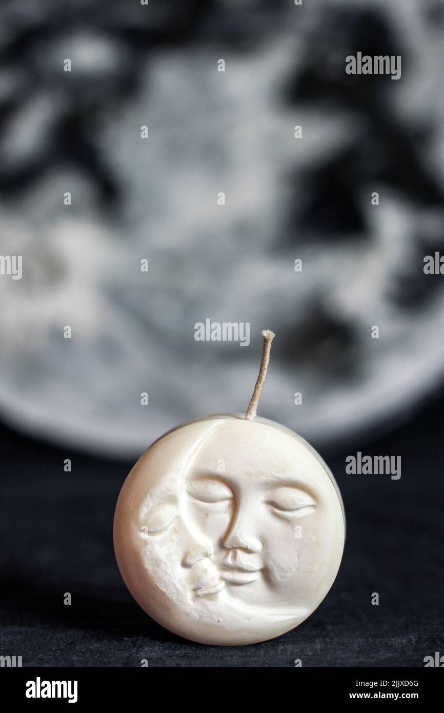 Candle in the shape of the moon. Lunar decor Stock Photo - Alamy