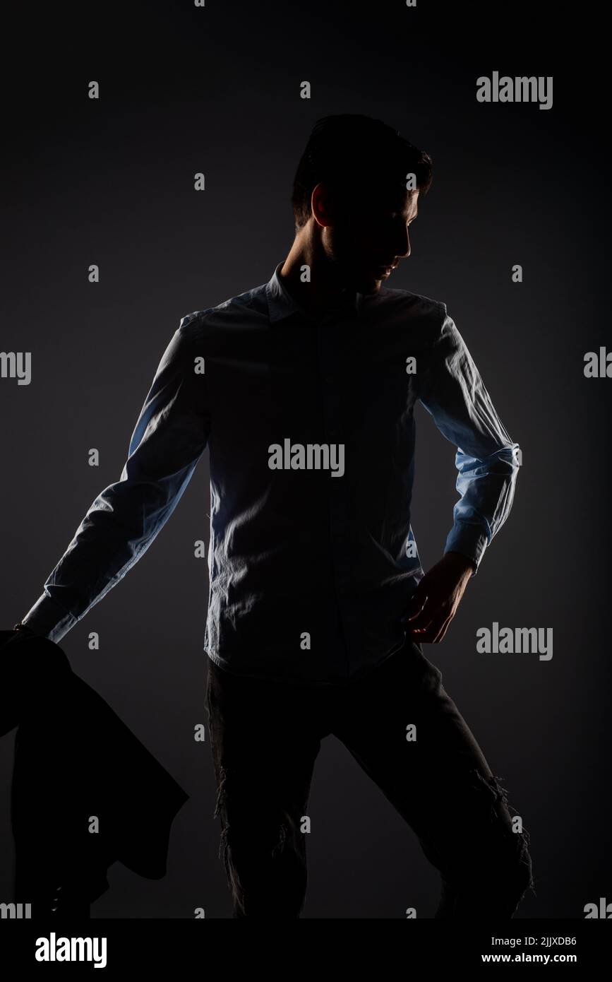 Attractive and handsome man in the studio setting himself up for the ...