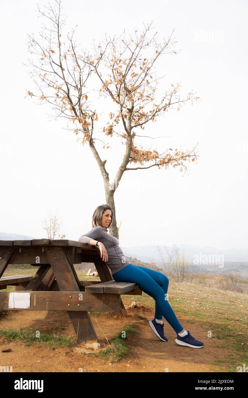Amazing girl relaxing on a bench from working out Stock Photo - Alamy