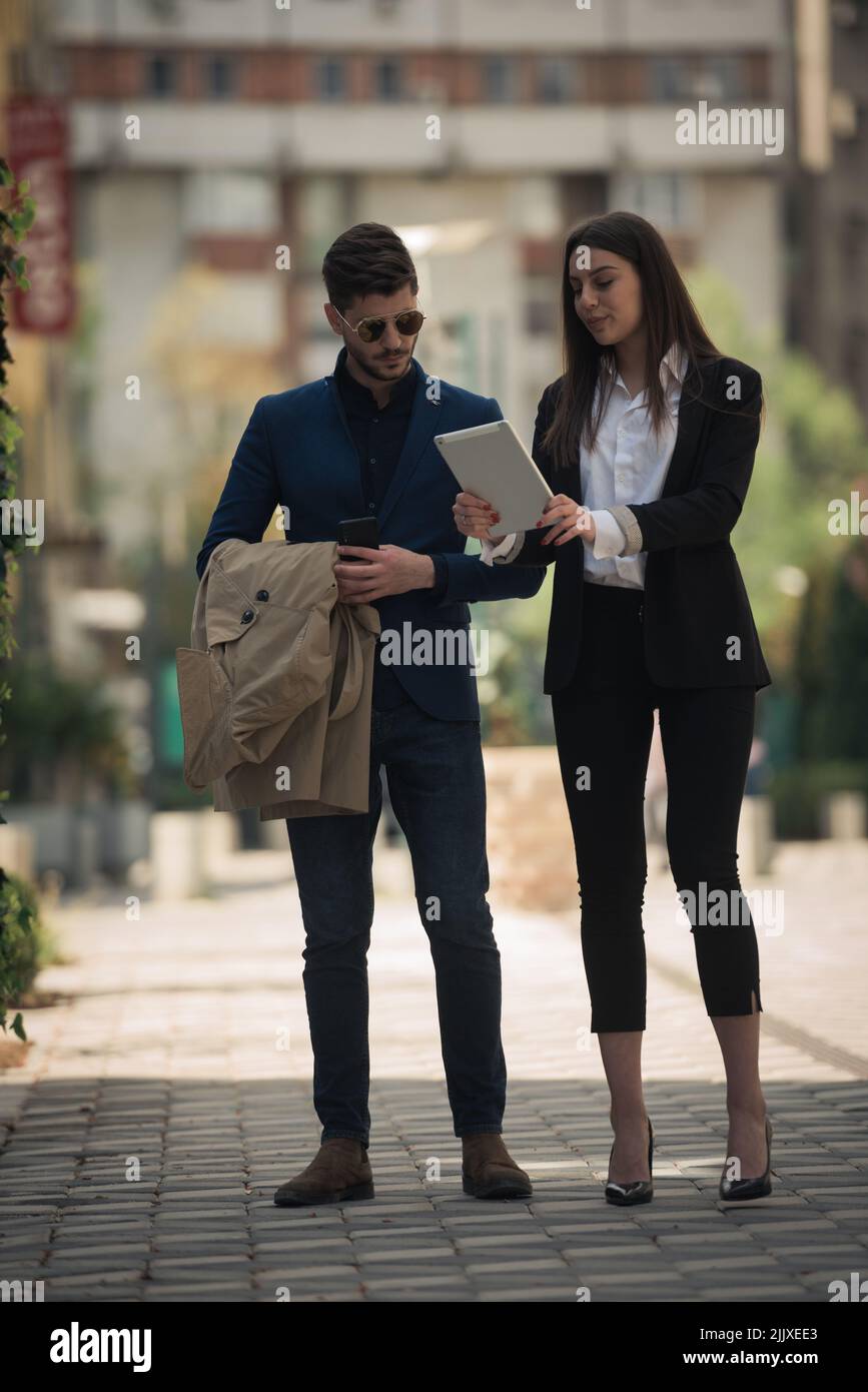 Male boss and his female assistent are looking at the results of his ...