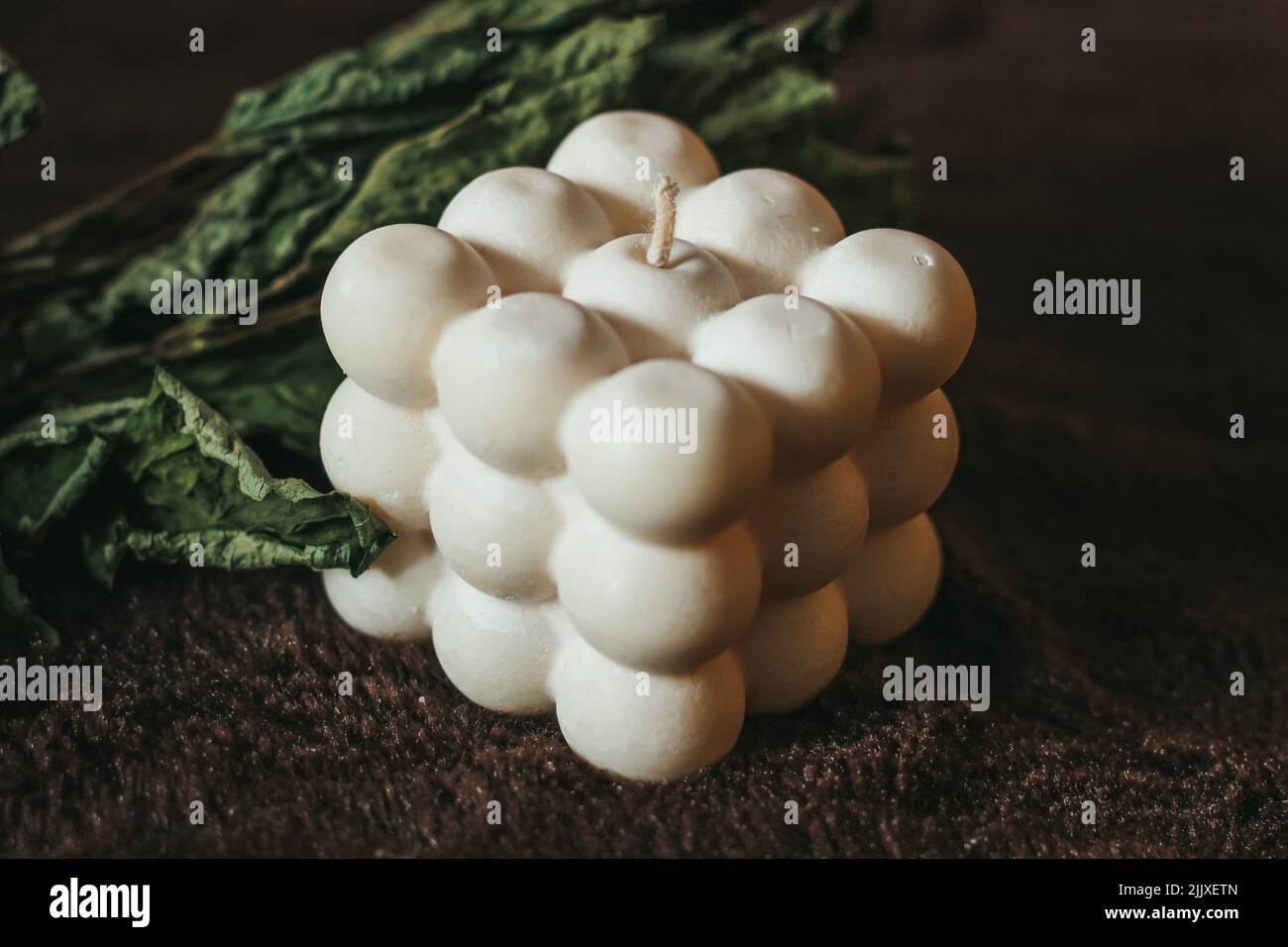 Candle cube from spheres. Fashion candle design Stock Photo - Alamy