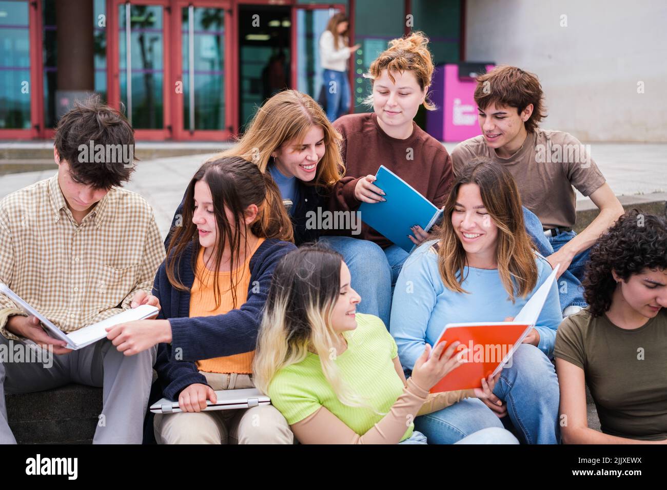 Group of students sharing books and notes before the exam Stock Photo ...
