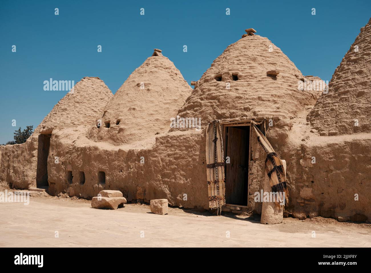 Beehive houses opposite bright clear sky Stock Photo - Alamy