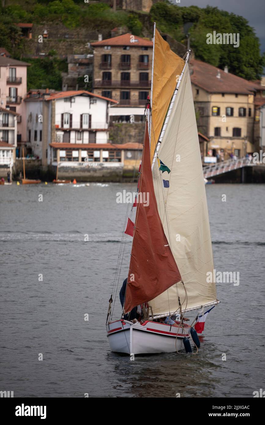 small sailing boat sailing in the port Stock Photo - Alamy